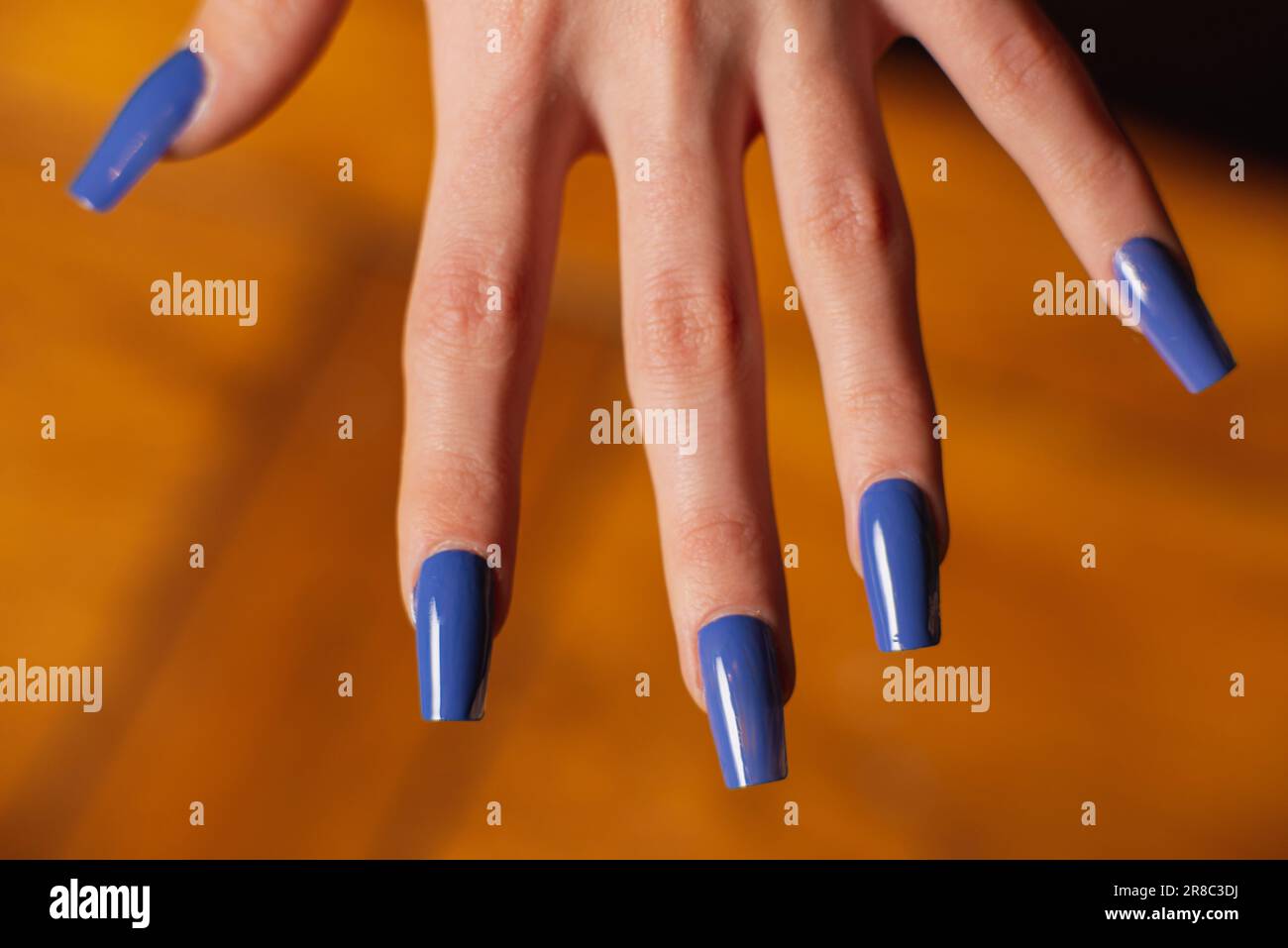 Manicure with long blue nails. Woman's hand close up Stock Photo - Alamy