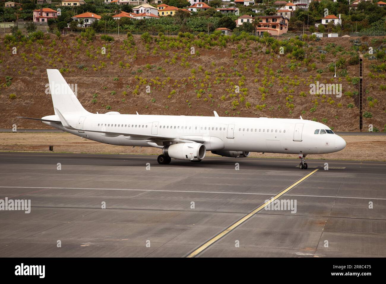 large airplane on runway at madeira airport Stock Photo - Alamy