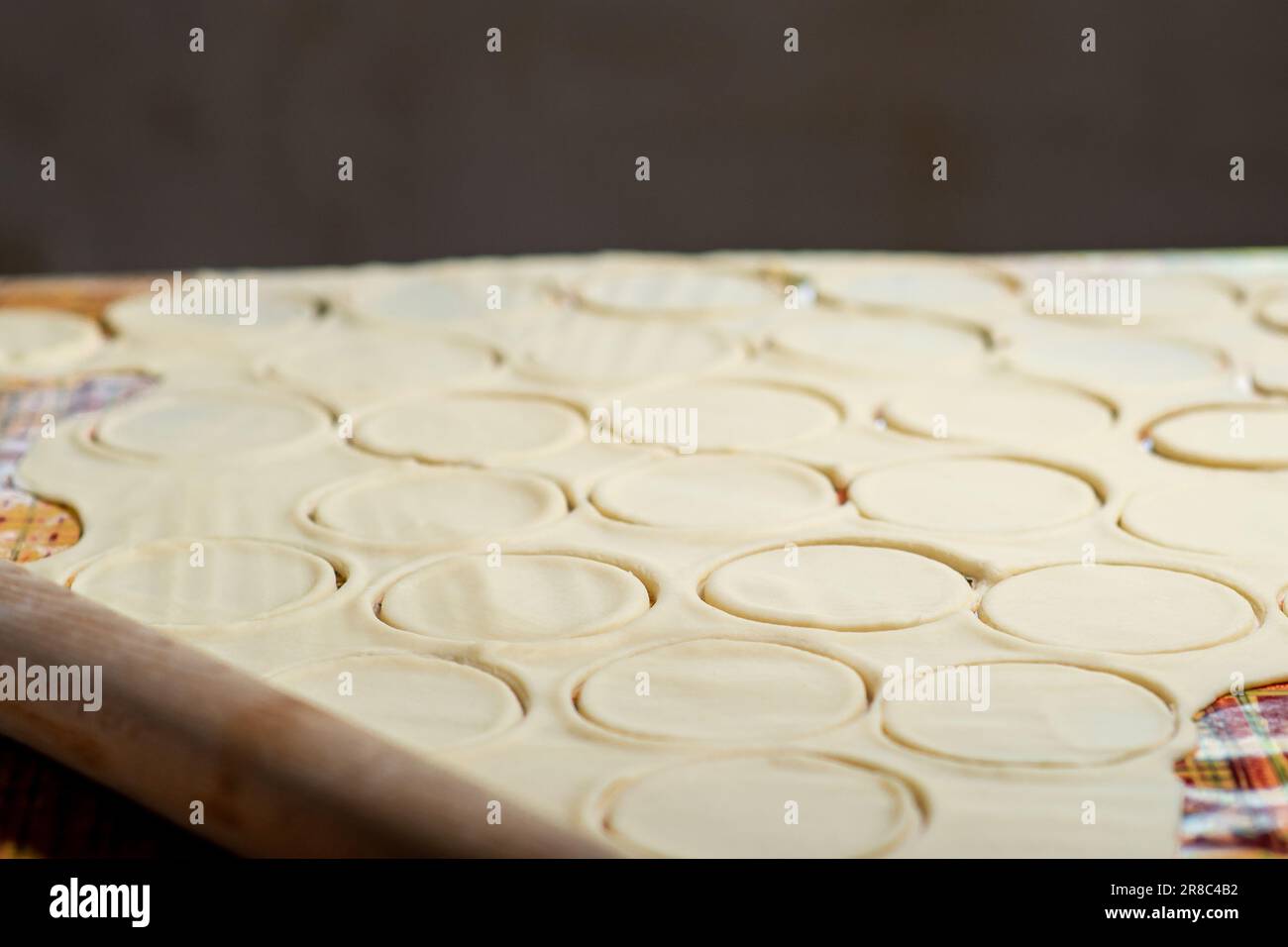 Dough with sliced circles for making variants. Food background. Dough ...