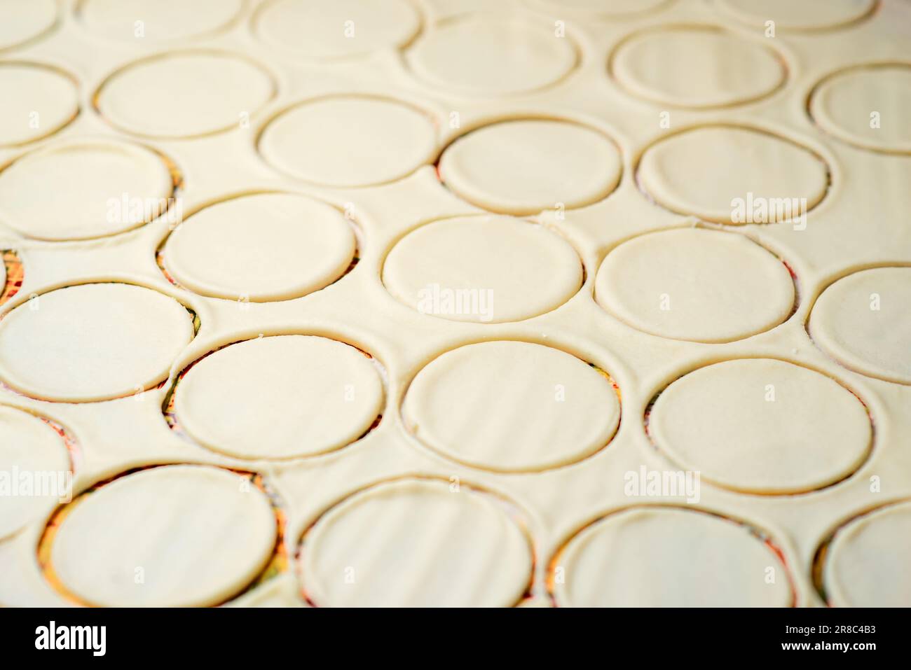 Dough with sliced circles for making variants. Food background. Dough ...