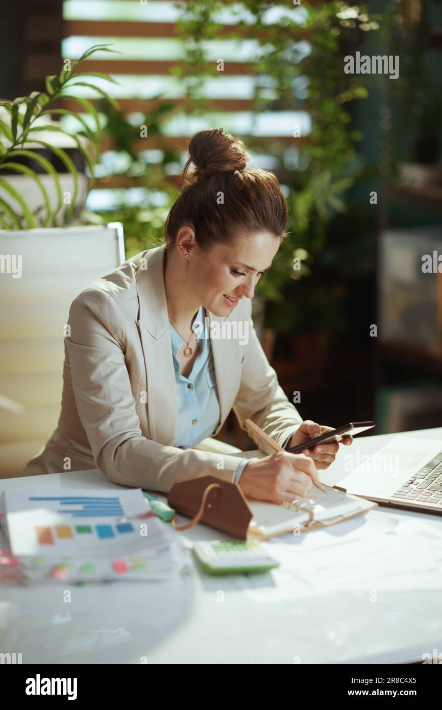 happy modern 40 years old woman employee in a light business suit in ...