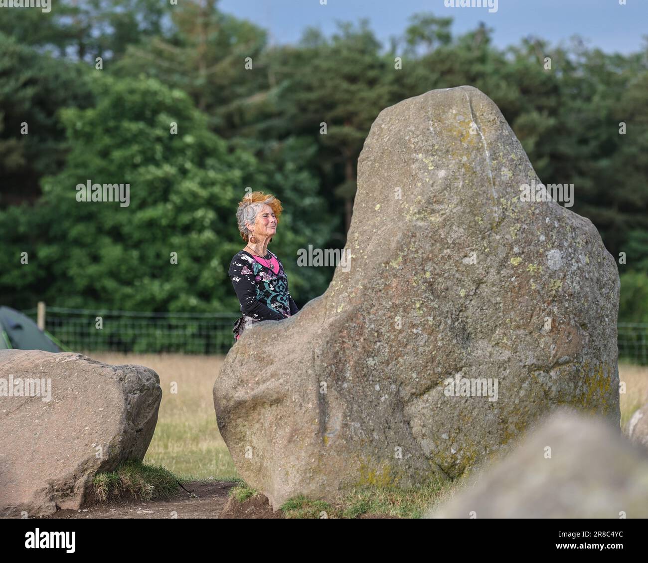 A person meditates inside the stone circle during the Castlerigg Stone ...