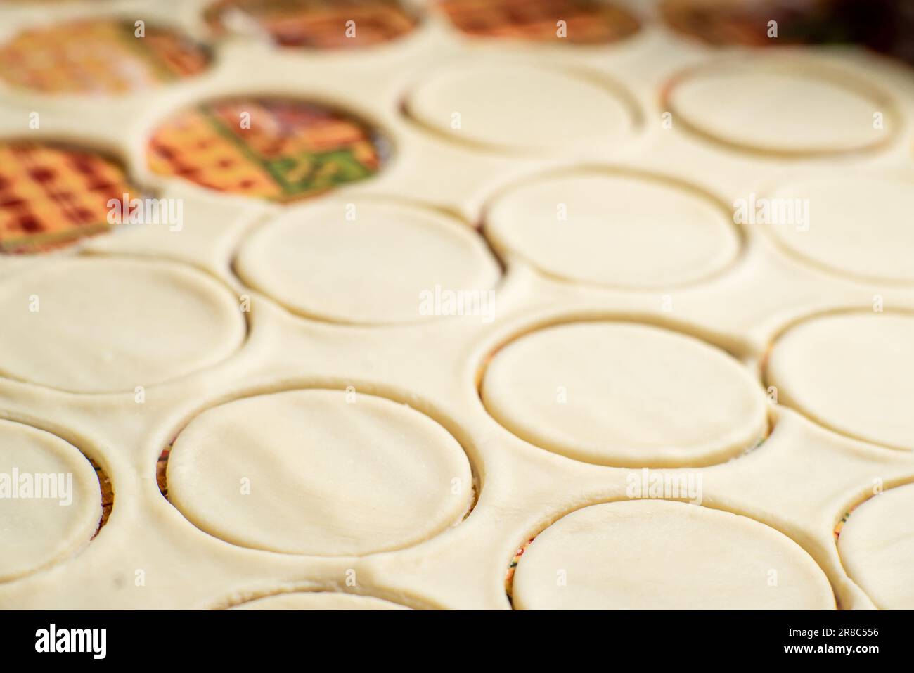 Dough with sliced circles for making variants. Food background. Dough ...