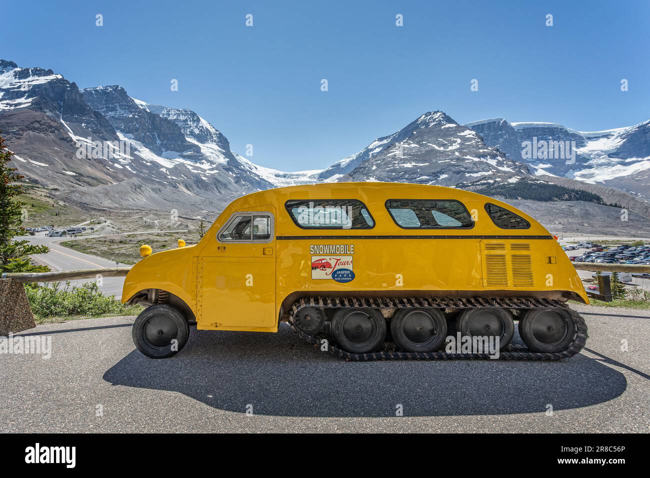 Vintage yellow snowmobile parked with view of Athabasca Glacier in ...