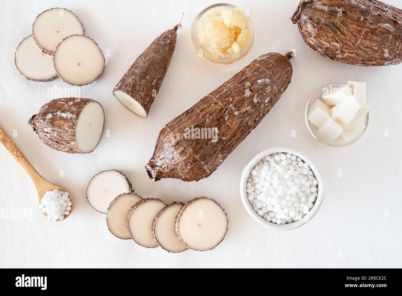 Close-up of a cassava root on a white background with tapioca pearls ...