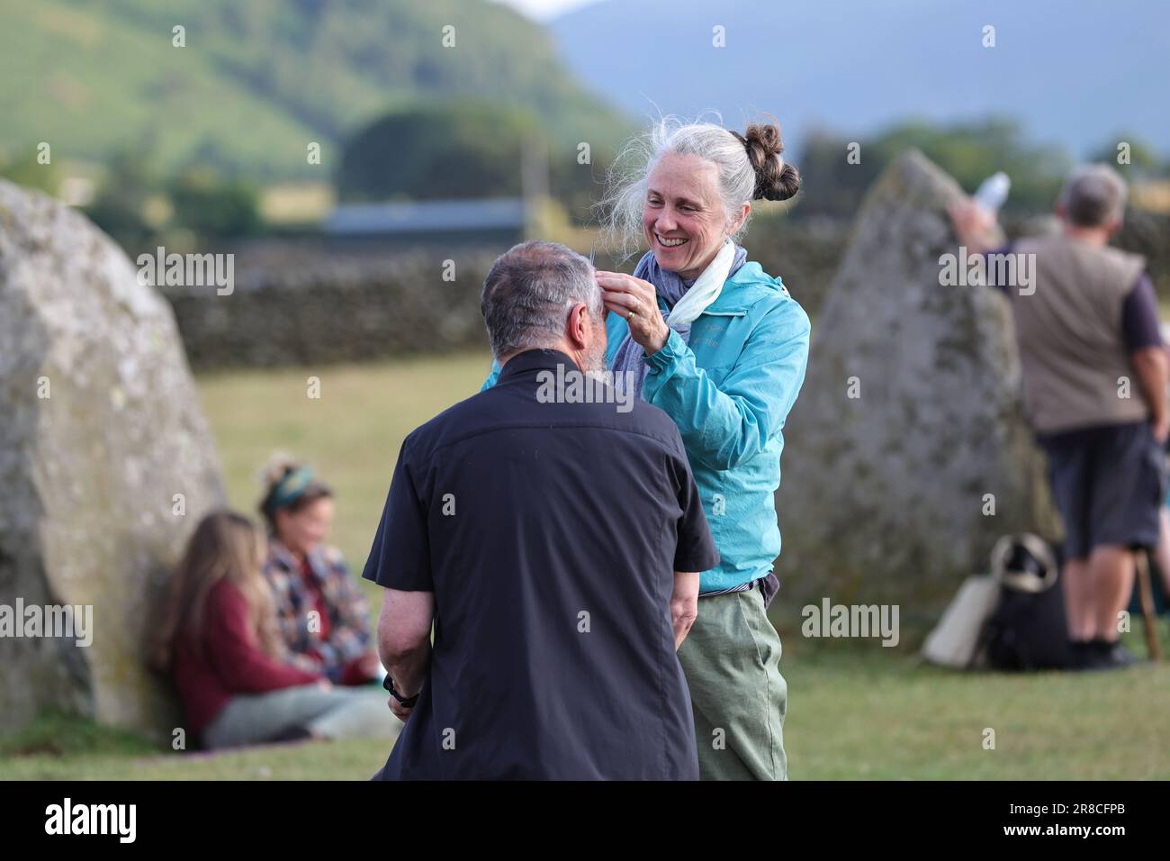 A person has their hair cut by their partner during the Castlerigg ...
