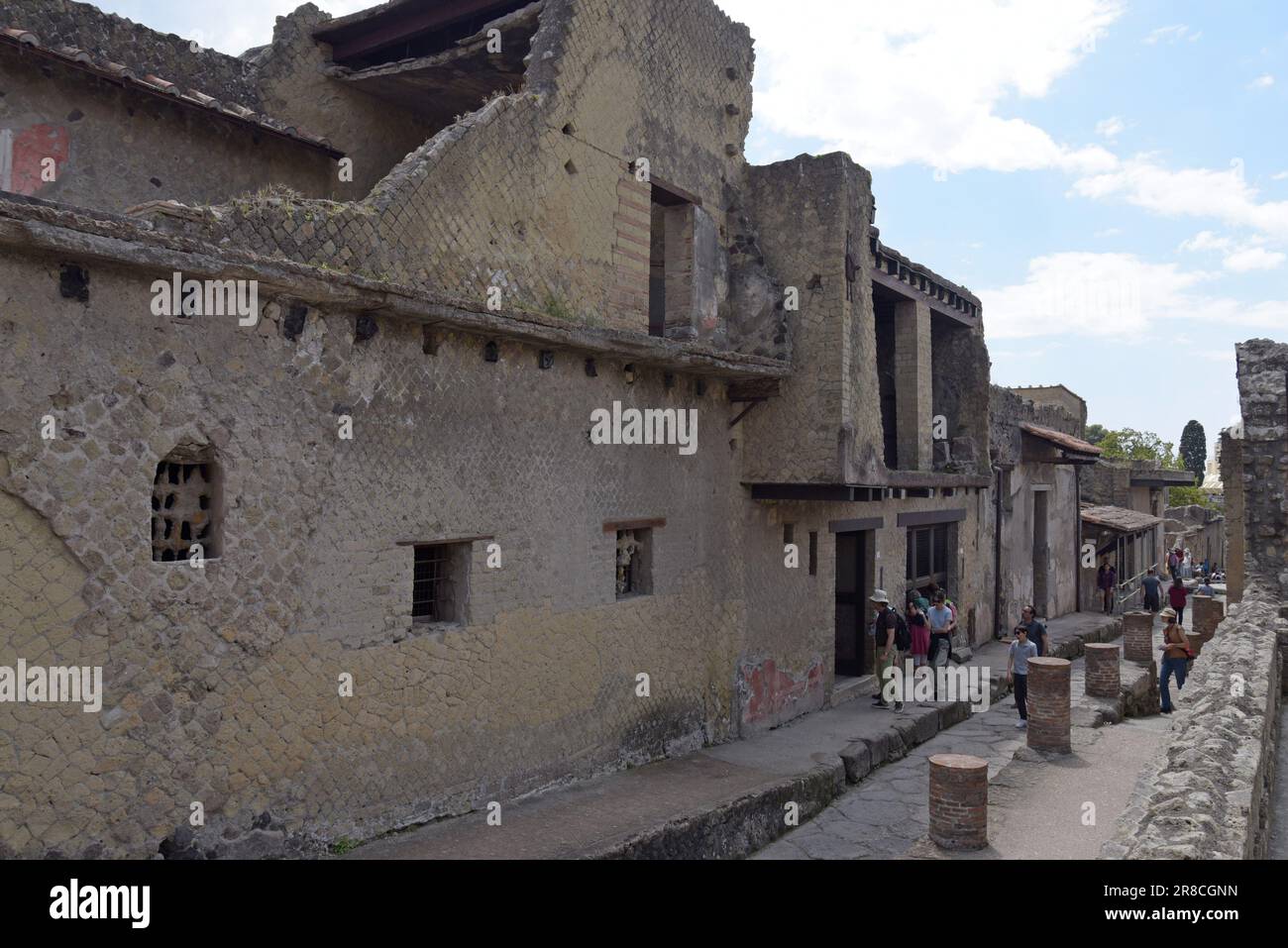 Tourists viewing the preserved Roman town of Herculaneumm buried in the ...
