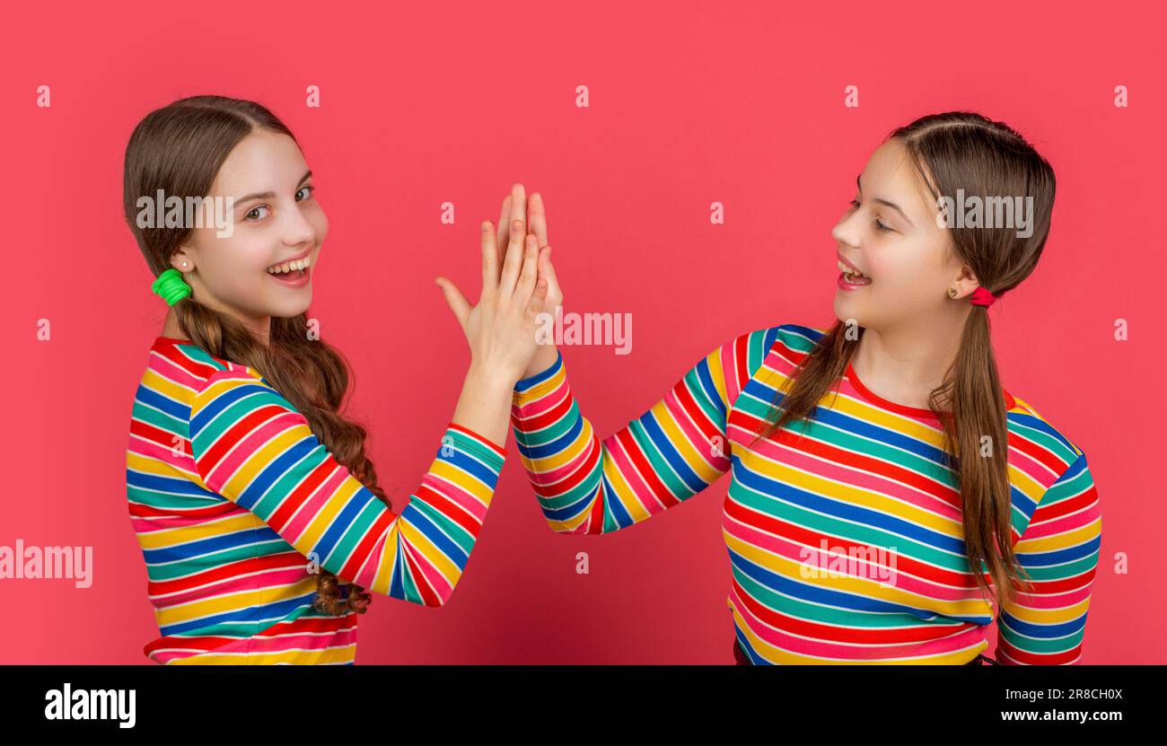 happy children embracing on pink background. greeting friendship Stock ...