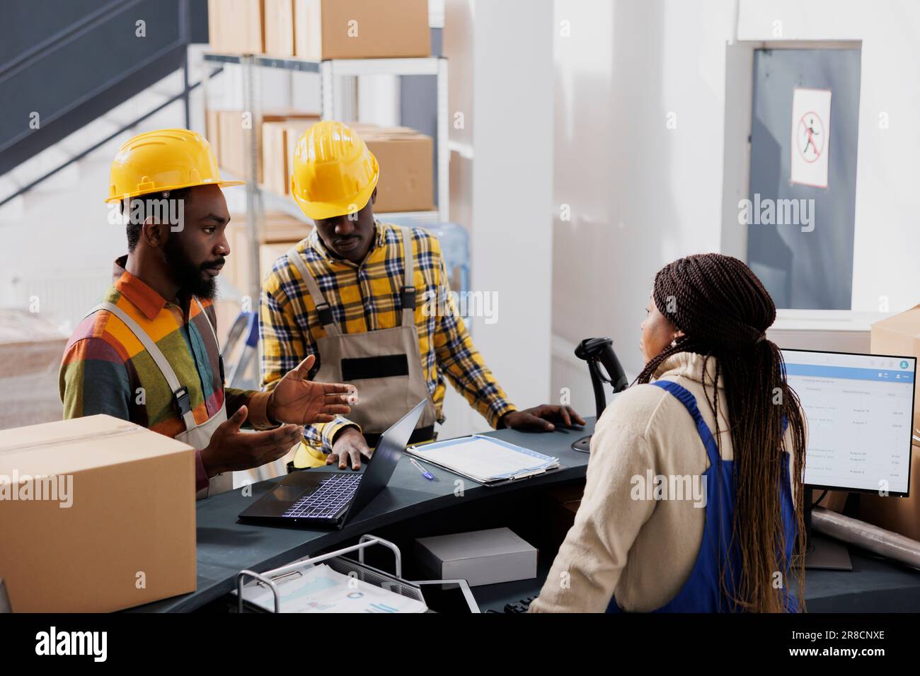 Warehouse workers asking postal manager about merchandise supply ...