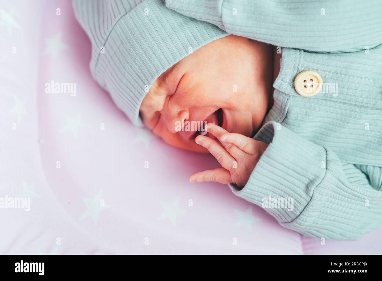 newborn baby crying lying in the crib. New born child tired and hungry ...