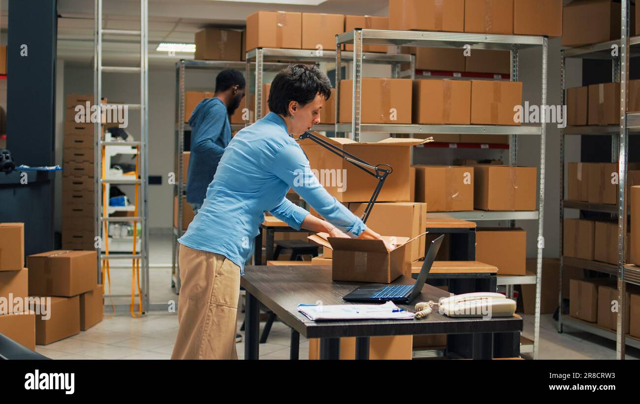 Young entrepreneur female sorting boxes hi-res stock photography and ...