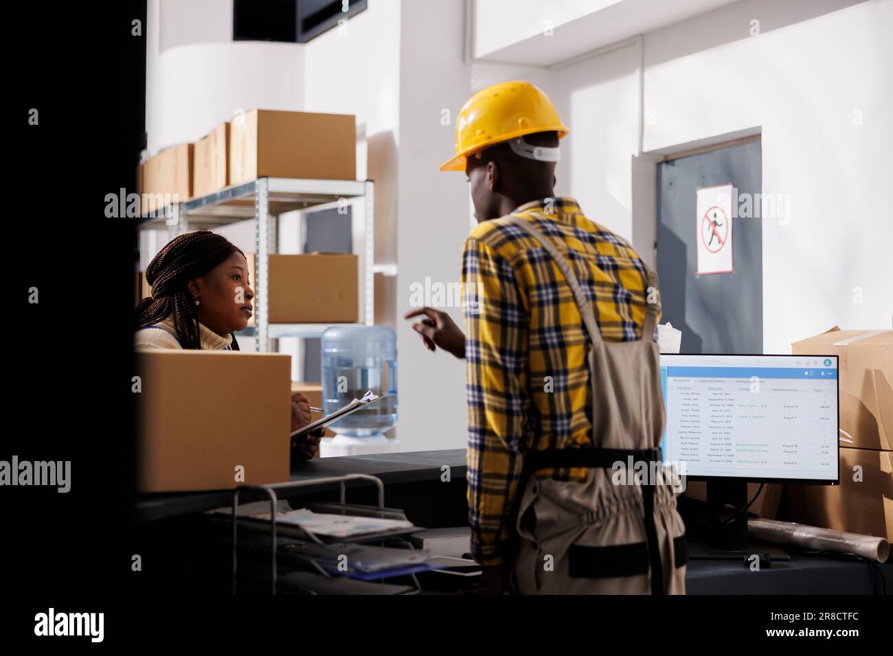 African american woman warehouse supervisor talking with manager at ...