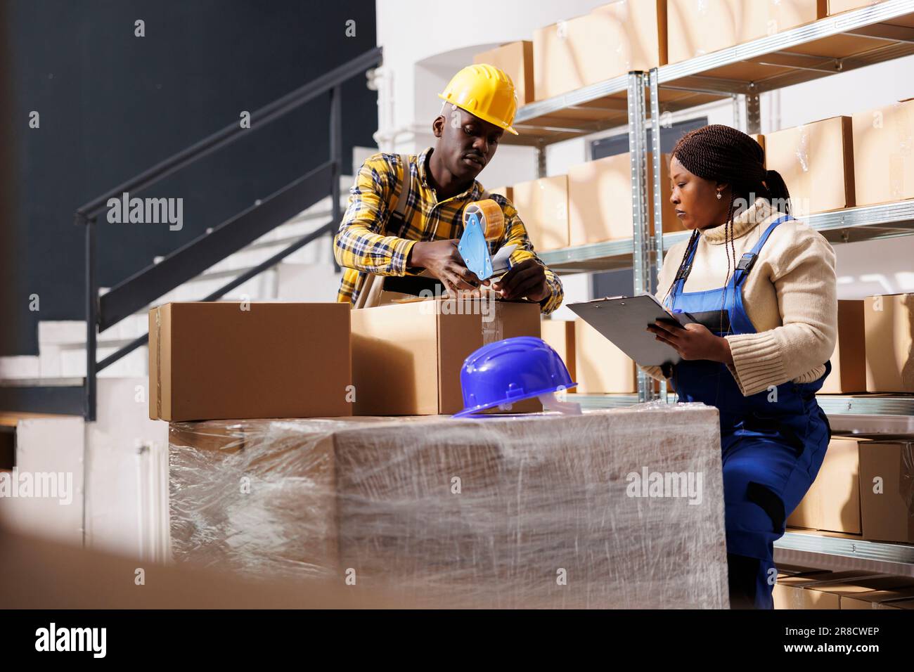 African american woman storehouse manager watching warehouse trainee ...