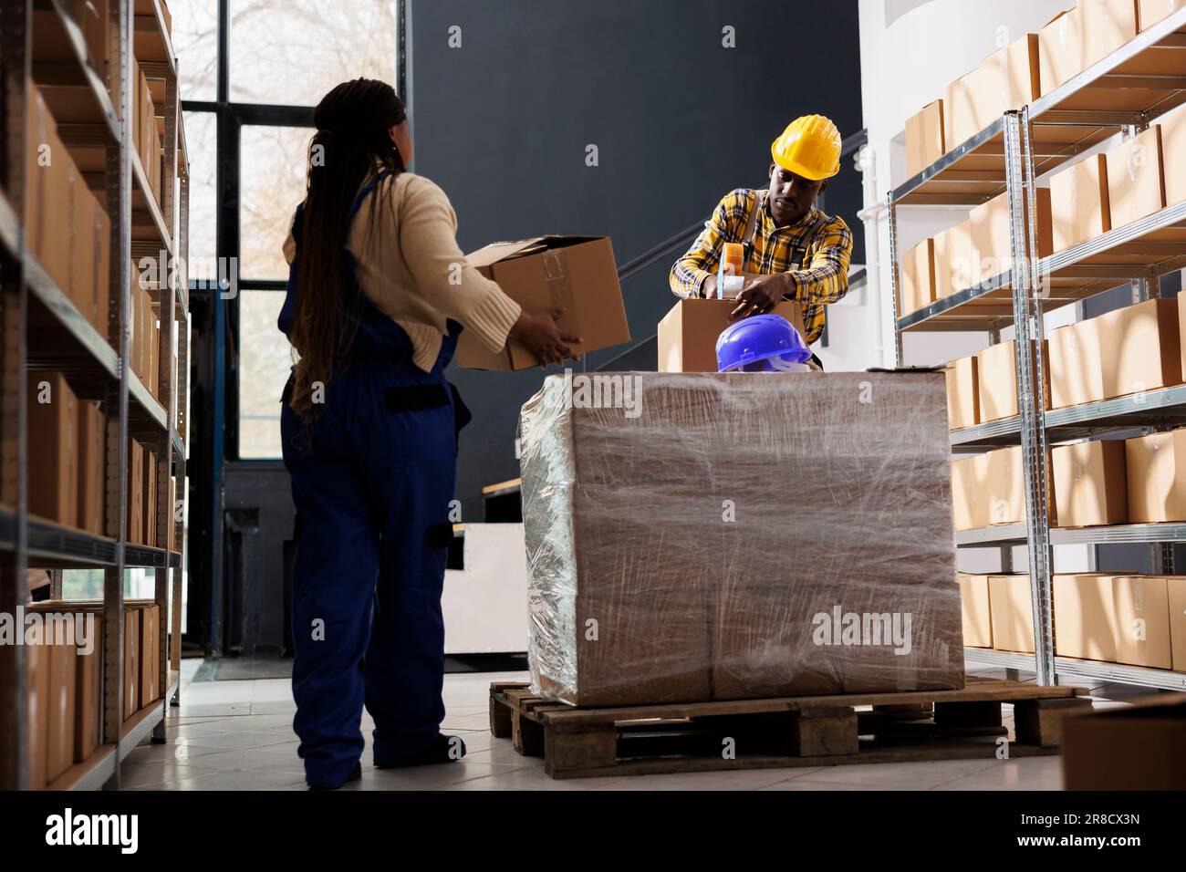 Package handler bringing parcels to warehouse worker for packing ...