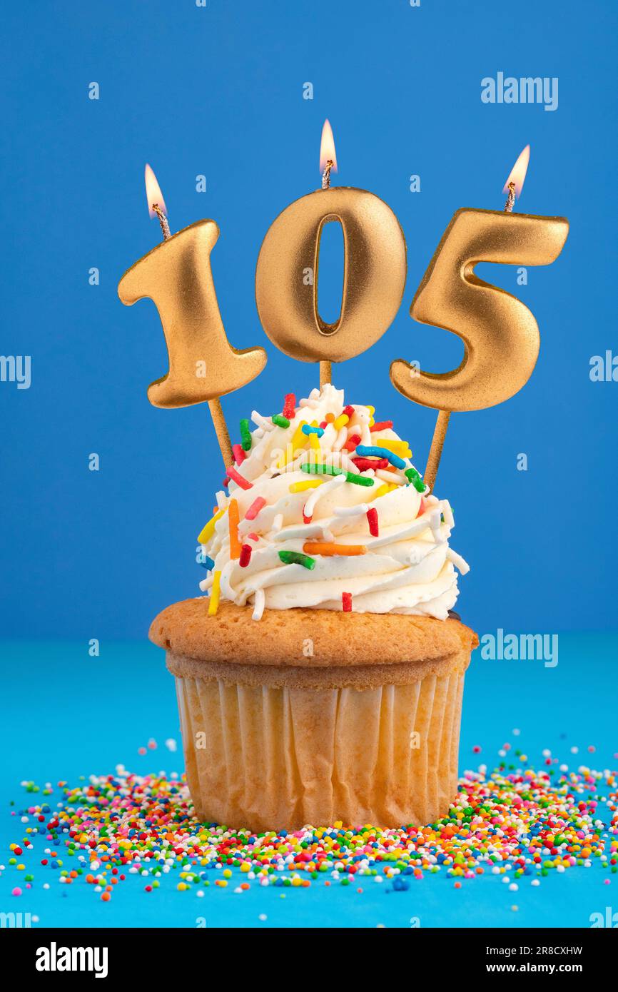 Candle number 105 - Cake birthday in blue background Stock Photo - Alamy