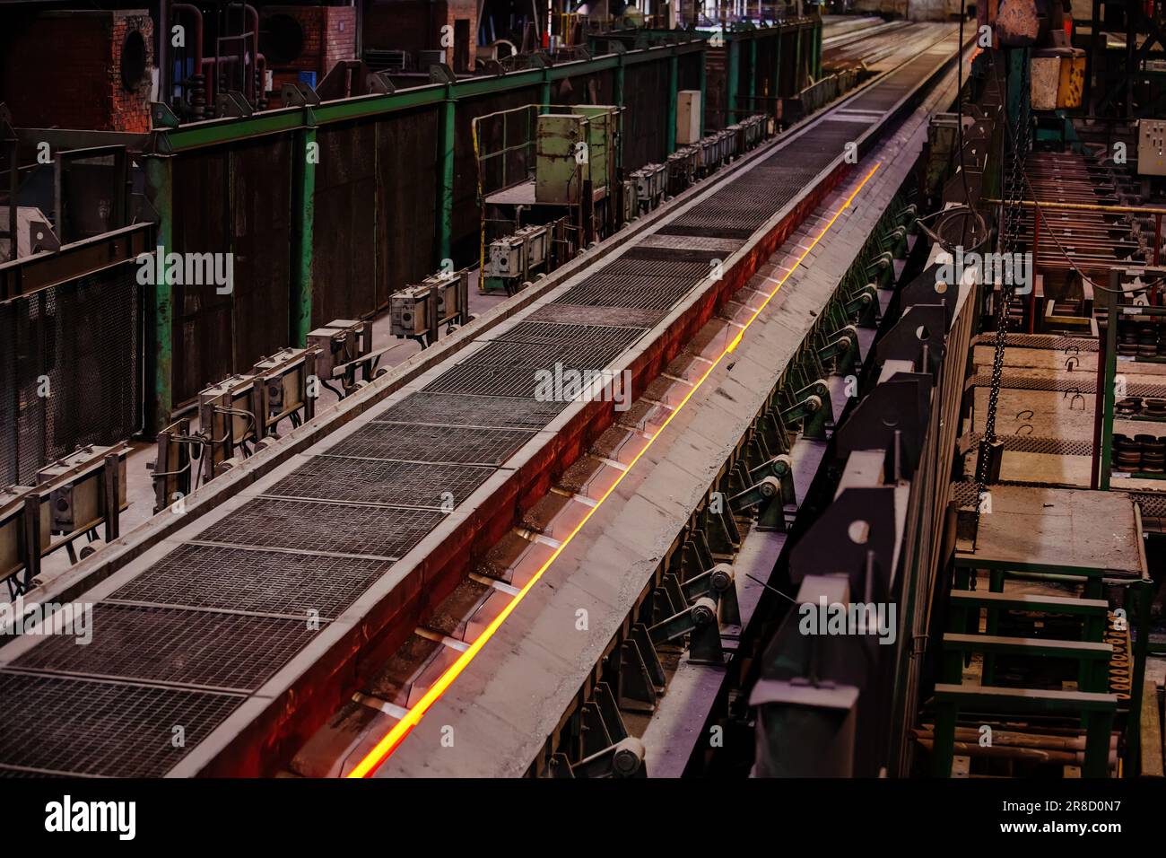 Rolled metal factory hot steel bar moving on conveyor Stock Photo - Alamy