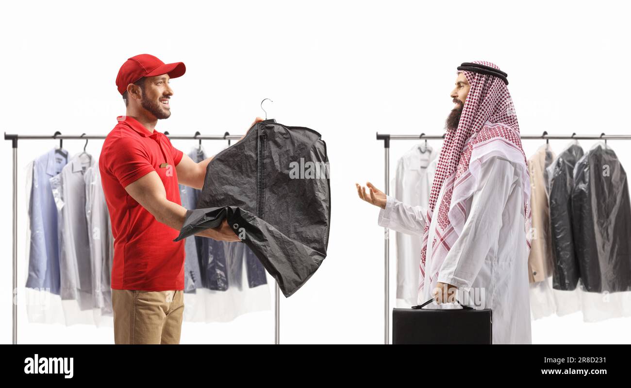 Man delivering dry cleaning clothes to an arab man in ethnic clothes ...