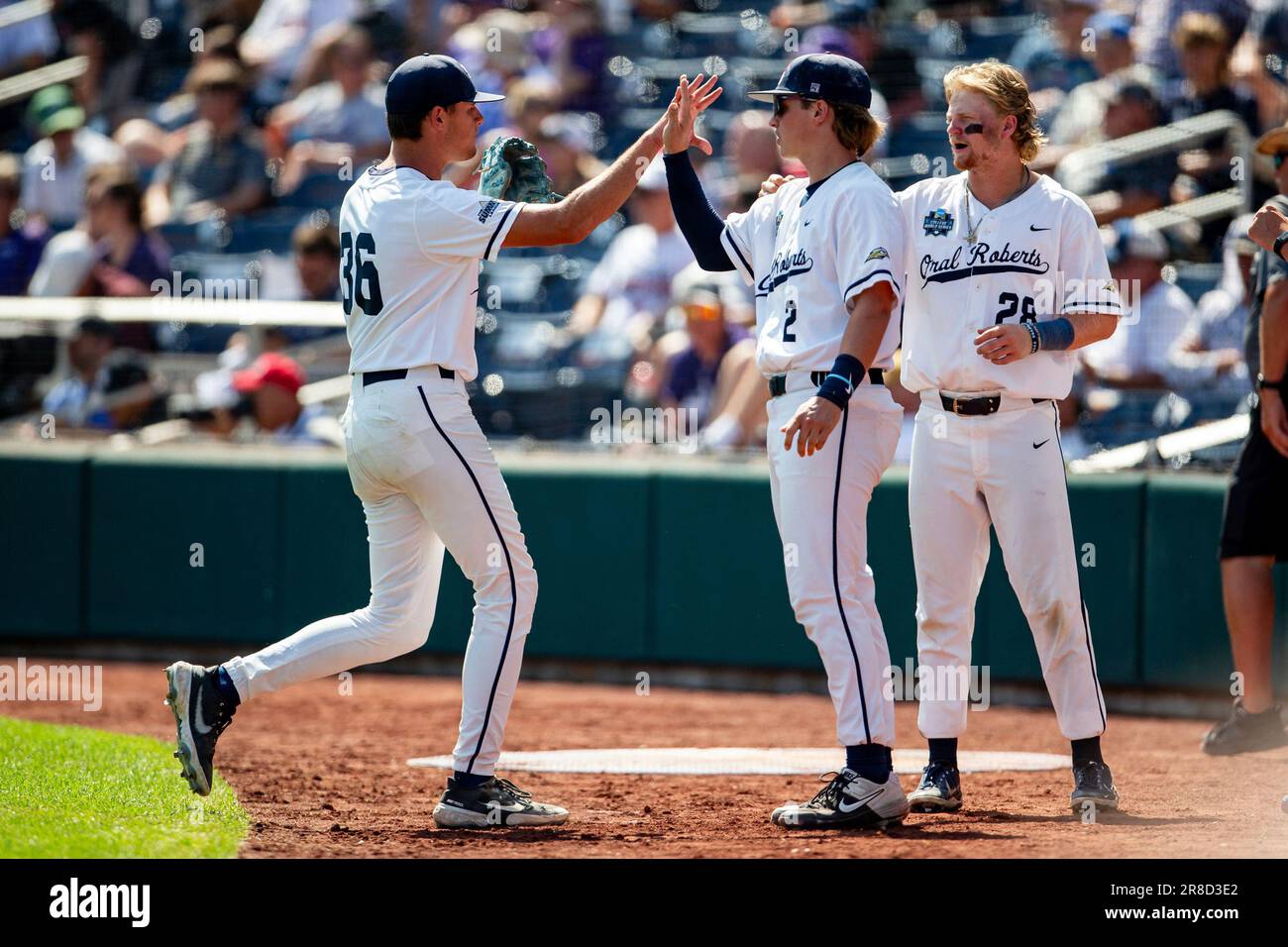 Oral Roberts pitcher Cade Denton (36) slaps hands with Dylan Wipperman ...
