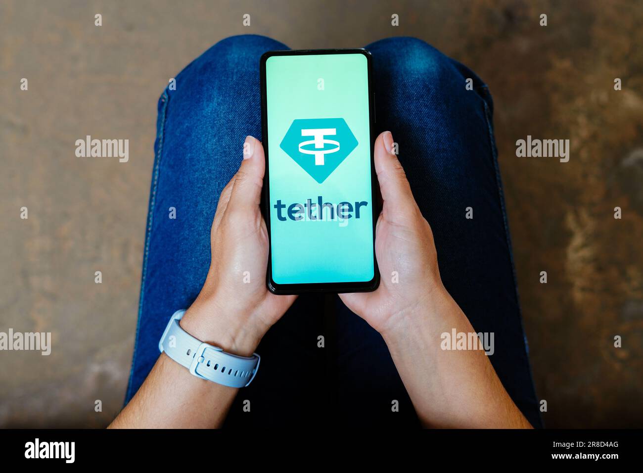 In this photo illustration, the Tether logo is displayed on a ...