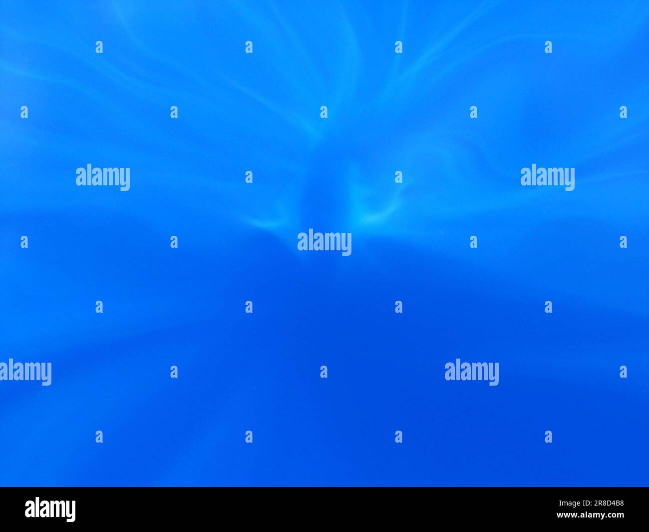 Radial light blue rays on saturated ocean blue background - backlit ...