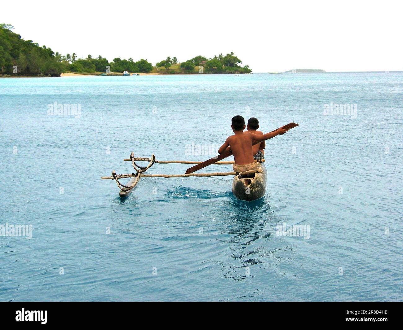 Children paddling in a canoe, two young Tongans in a dugout proa Stock ...