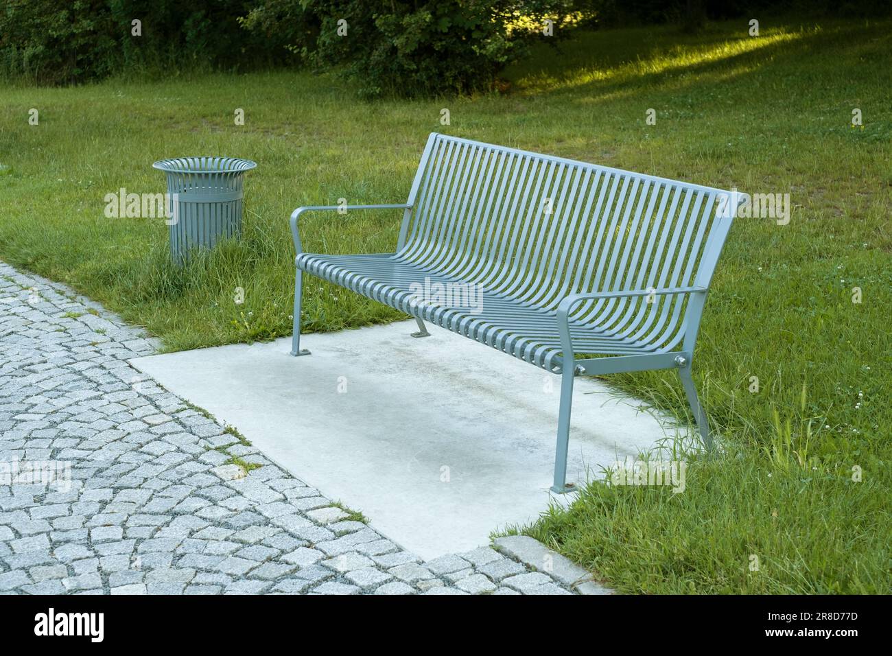 Modern Metal bench in the city park Stock Photo - Alamy