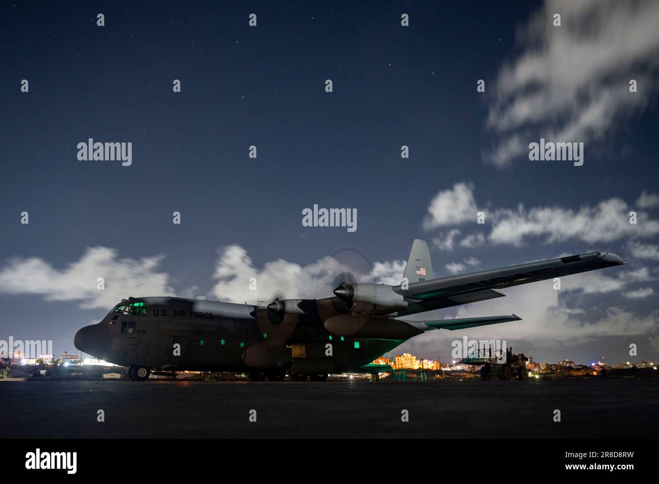 Cargo is offloaded from a C-130H assigned to the 75th Expeditionary ...