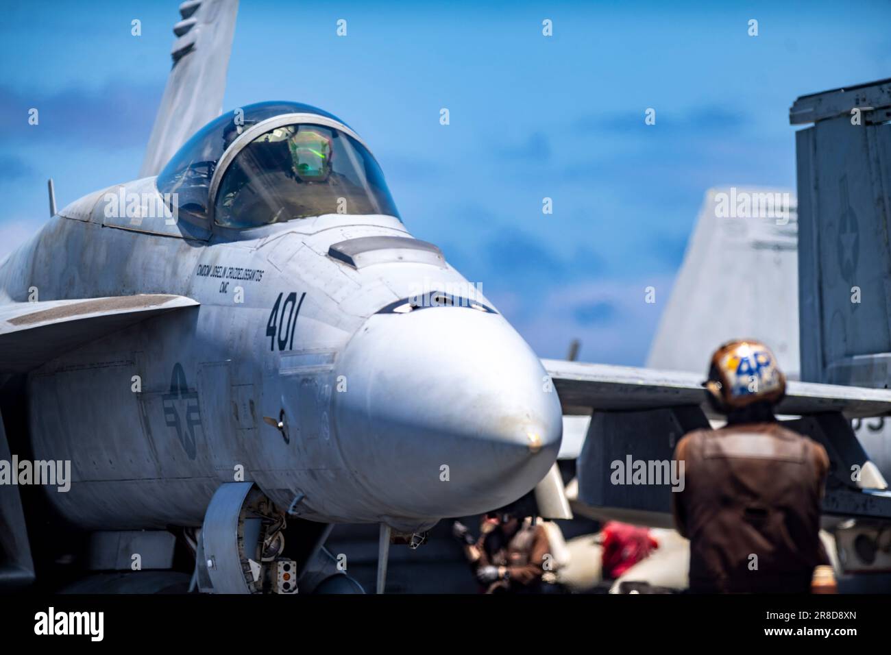 230618-N-DU622-1019 PACIFIC OCEAN (June 18, 2023) A U.S. Navy Sailor directs an F/A-18E Super ...