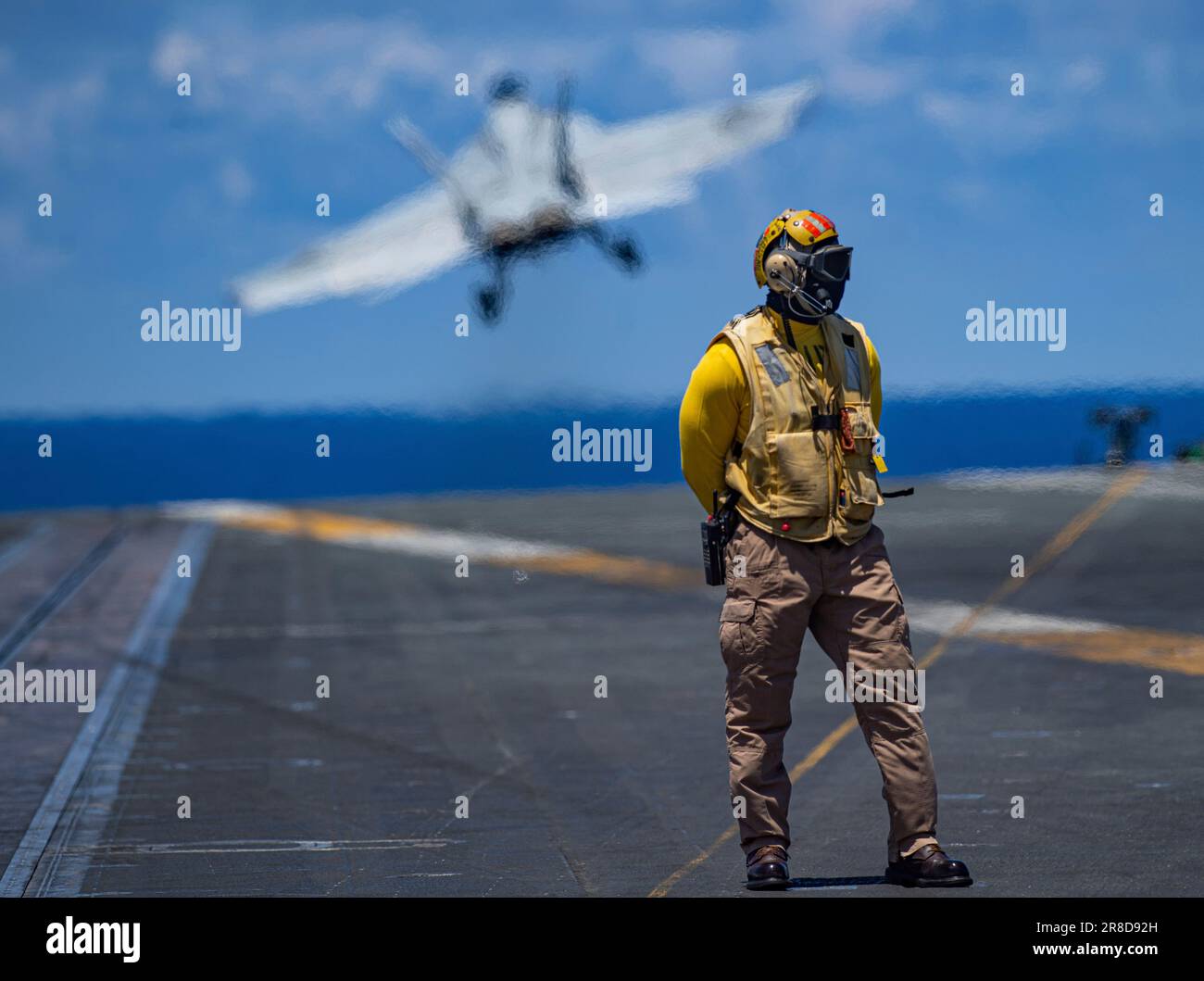 230618-N-DU622-1207 PACIFIC OCEAN (June 18, 2023) A U.S. Navy Sailor observes flight operations ...