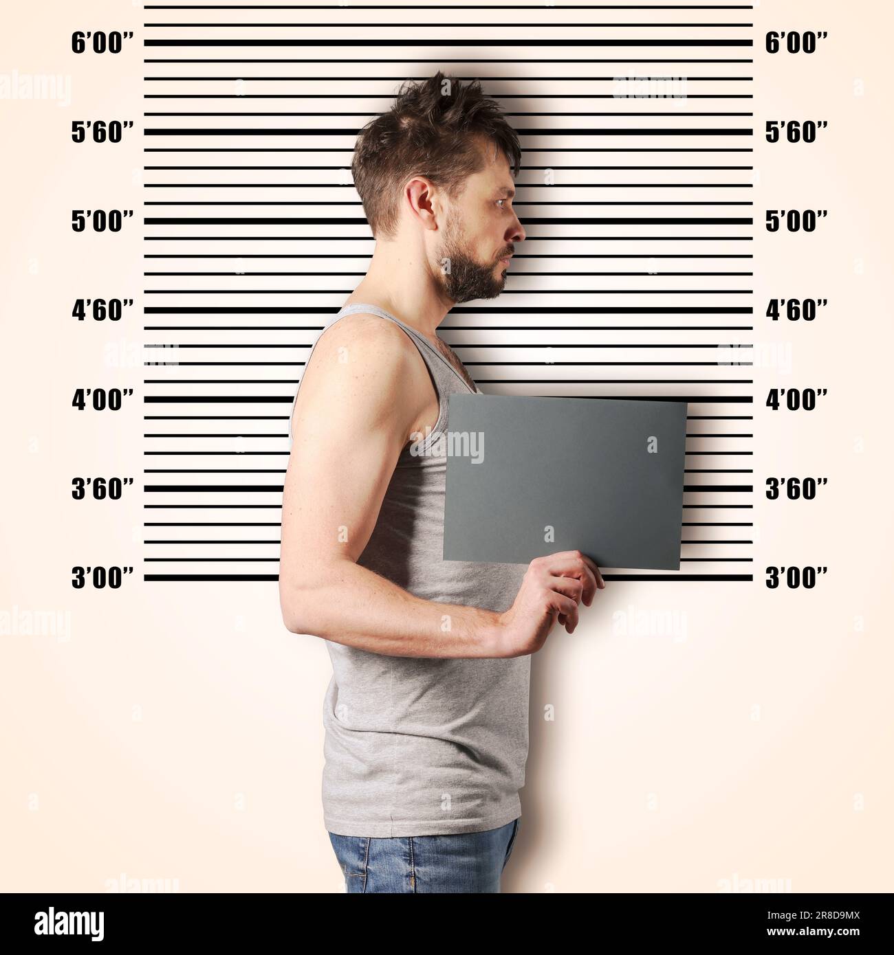 Criminal mugshot. Arrested man with blank card against height chart ...