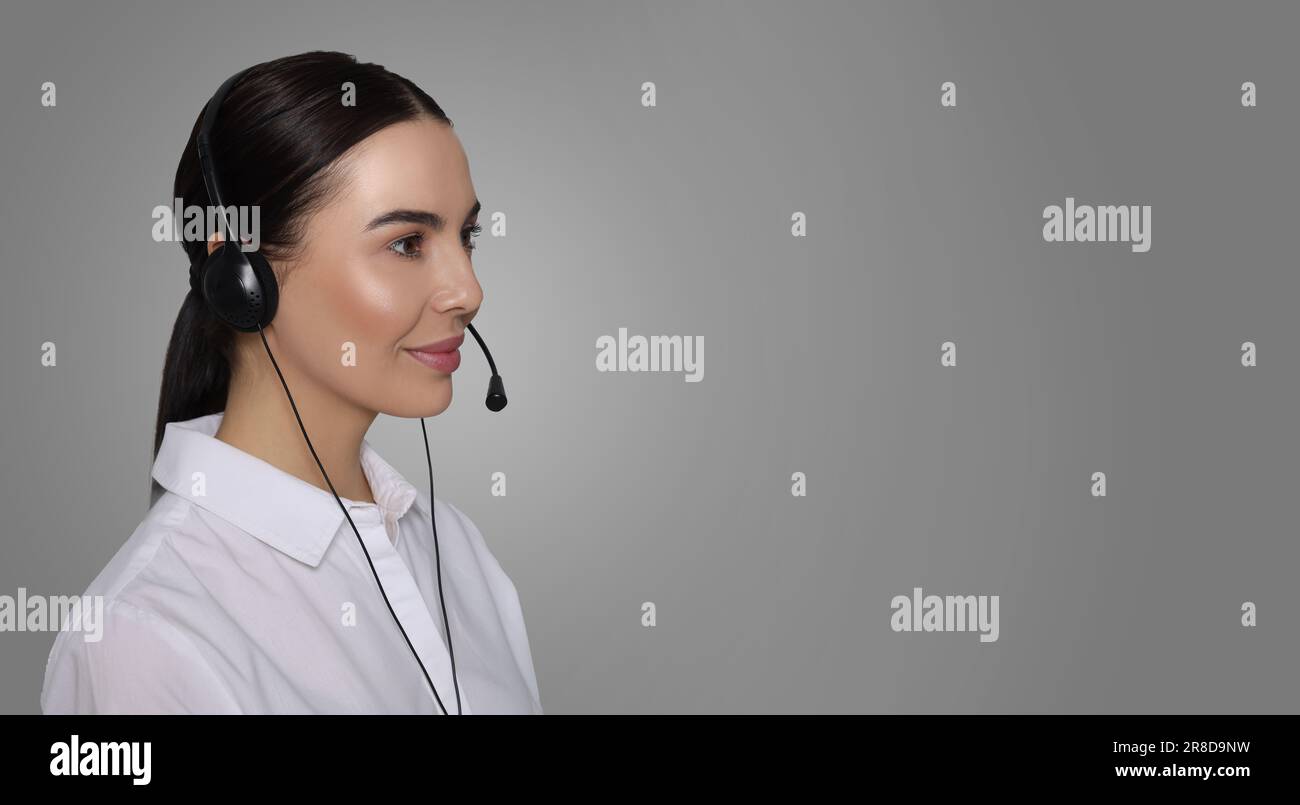 Hotline operator with headset on light grey background, space for text ...