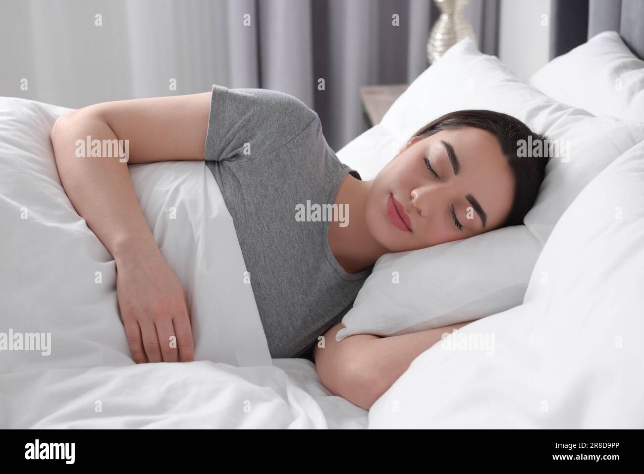 Beautiful young woman sleeping in soft bed at home Stock Photo - Alamy