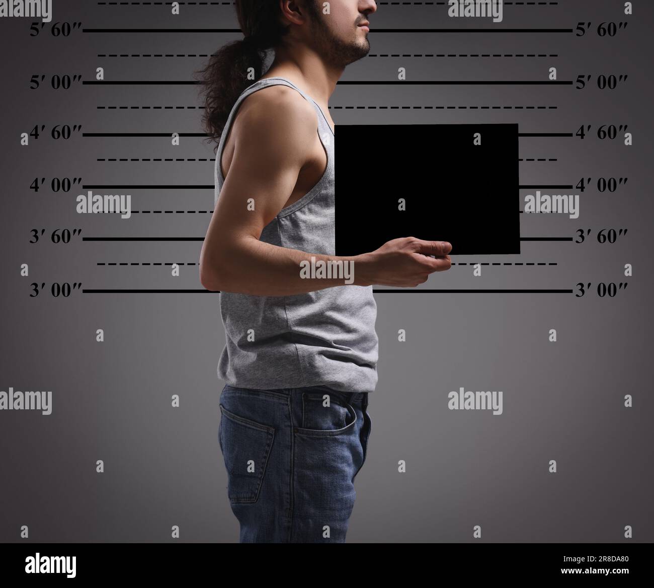 Criminal mugshot. Arrested man with blank card against height chart ...