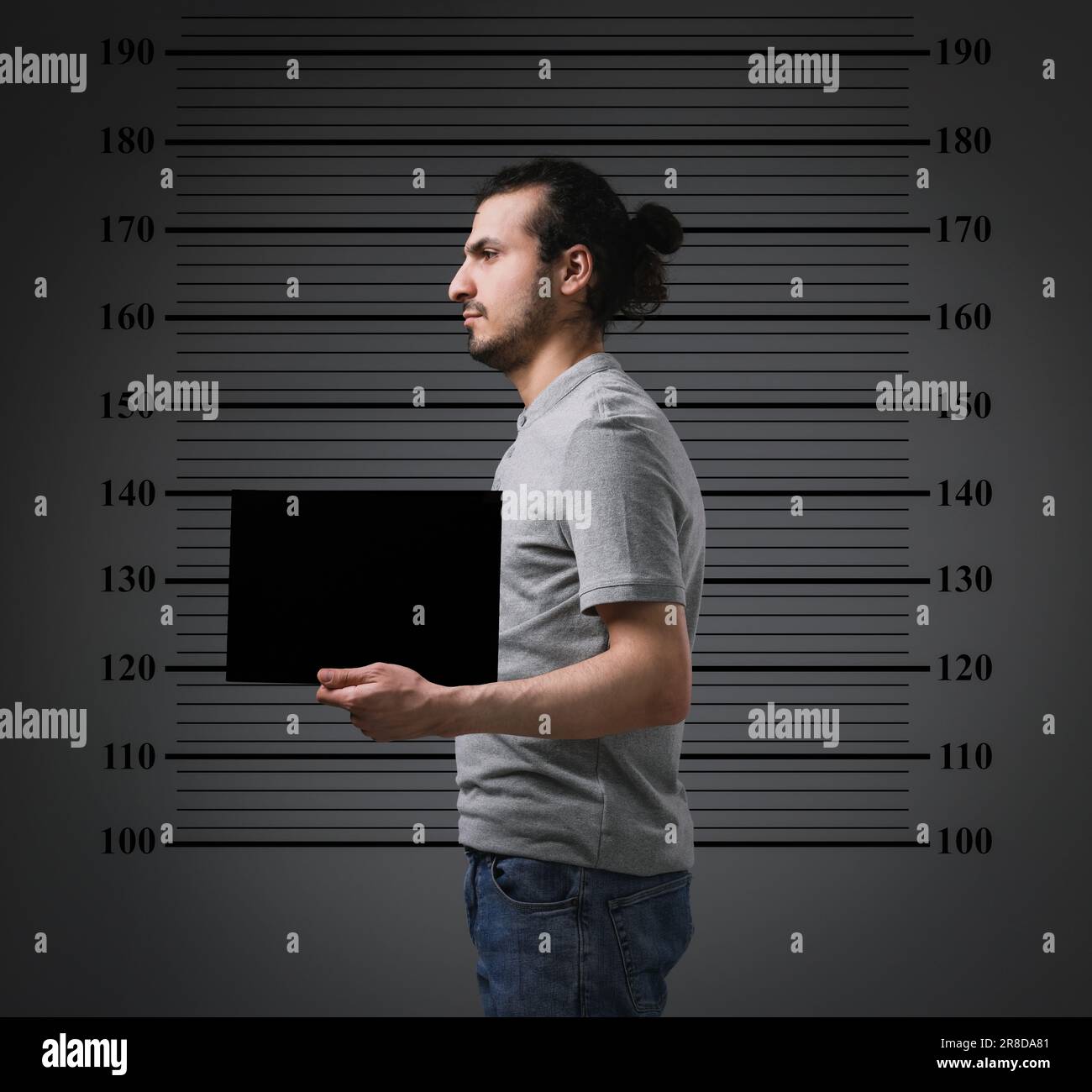 Criminal mugshot. Arrested man with blank card against height chart ...