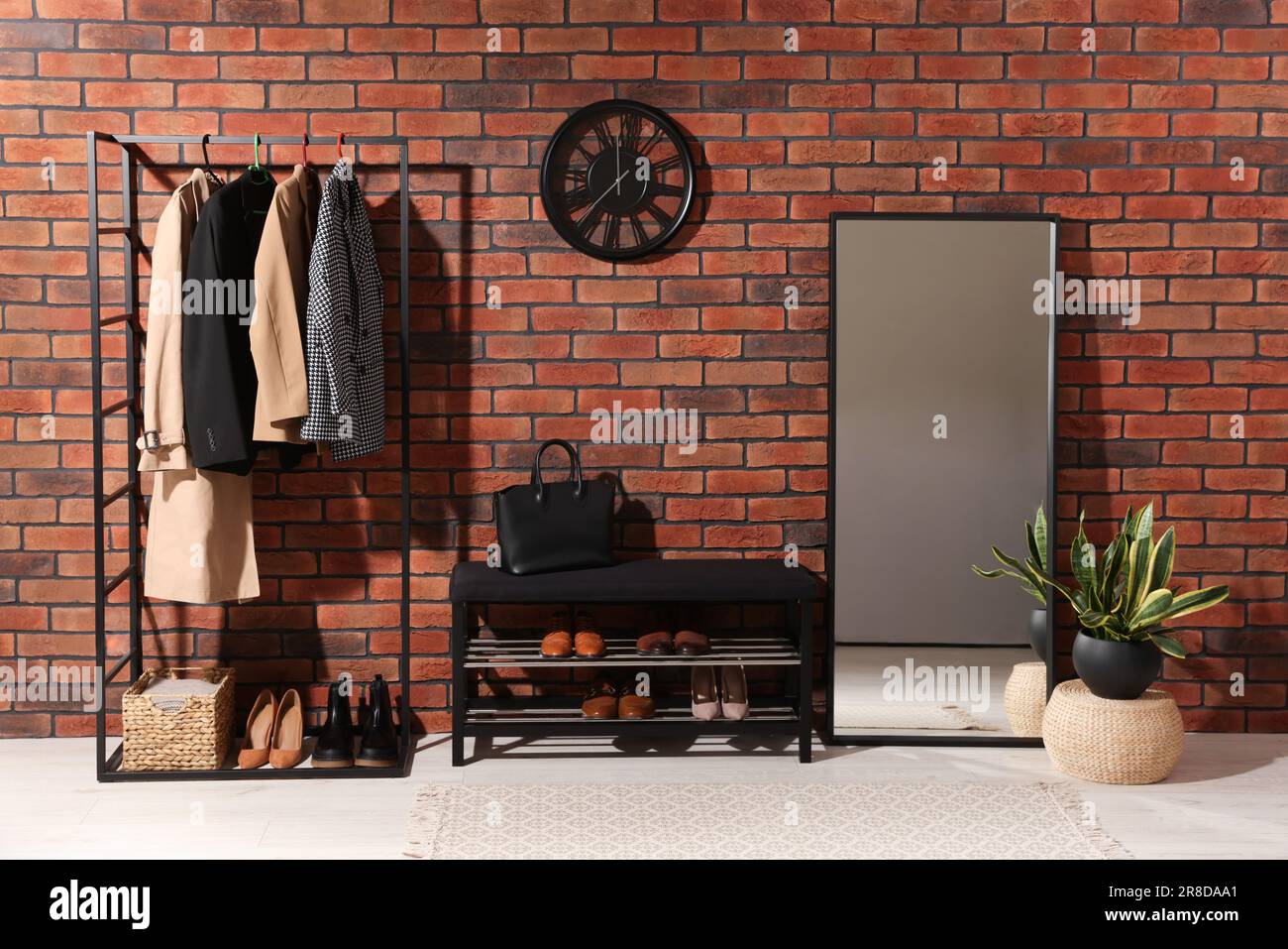 Stylish hallway with coat rack, mirror and shoe storage bench near ...