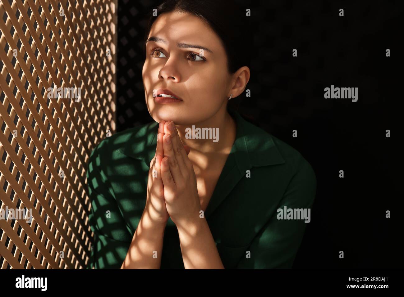 Young woman during confession in church hi-res stock photography and ...
