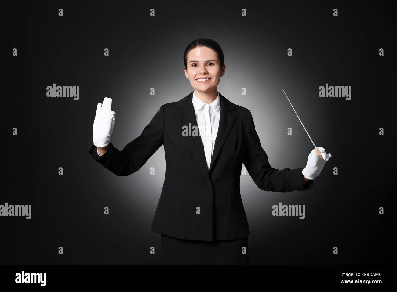 Happy professional conductor with baton on black background Stock Photo ...