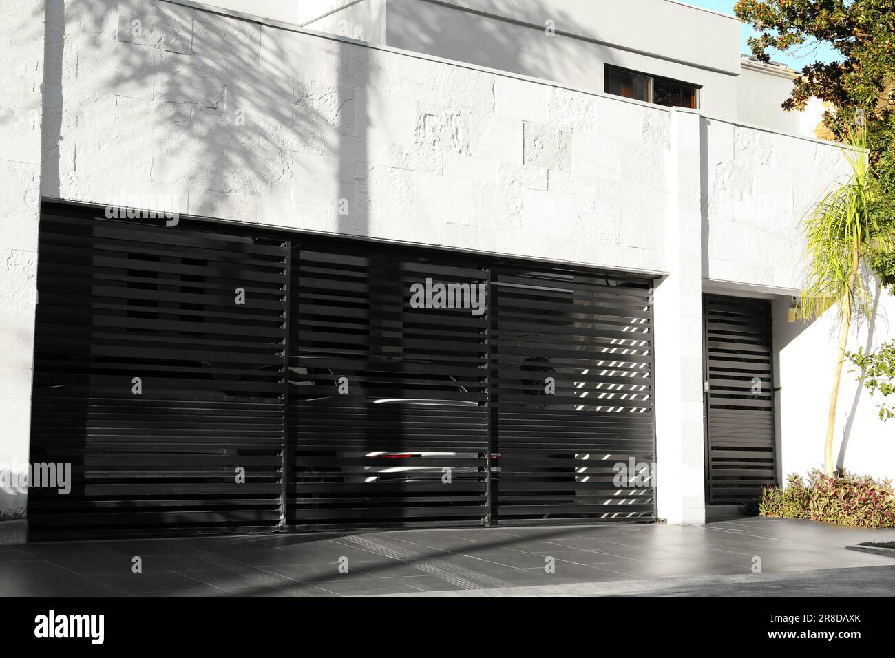 Closed gates of modern garage. Exterior design Stock Photo - Alamy