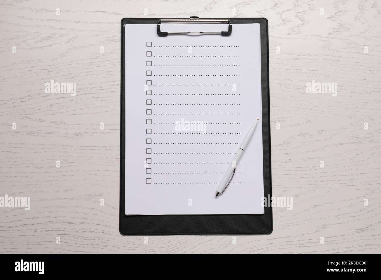 Clipboard with checkboxes and pen on wooden table, top view Stock Photo ...