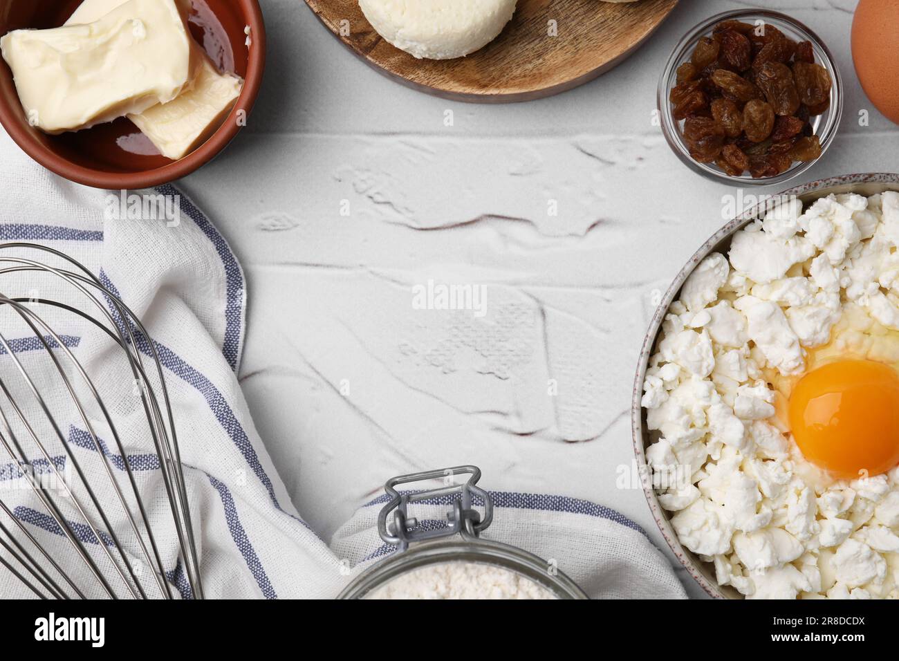 Flat lay composition with different ingredients on white textured table ...