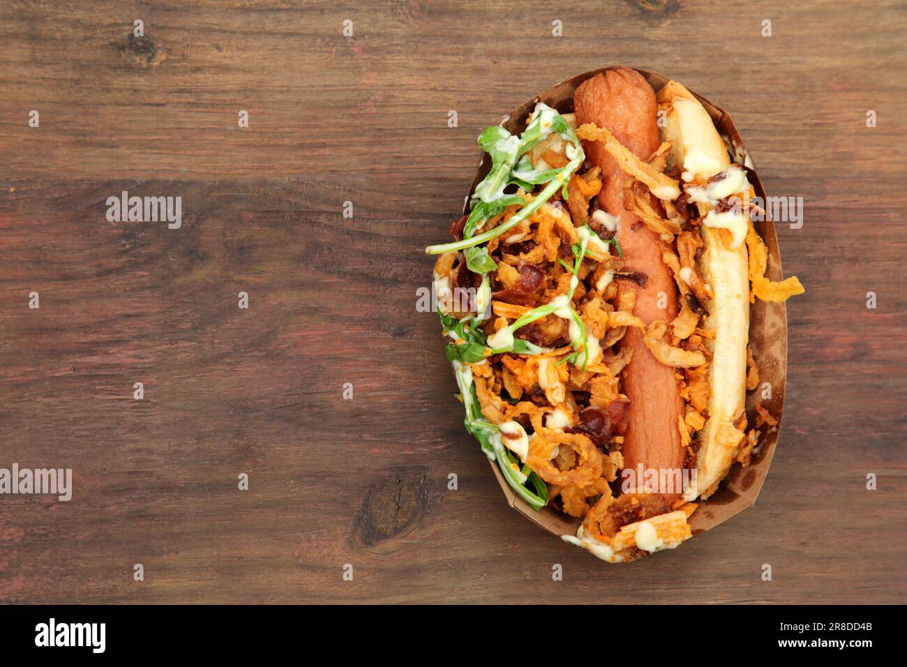 Fresh delicious hot dog on wooden table, top view. Space for text Stock ...
