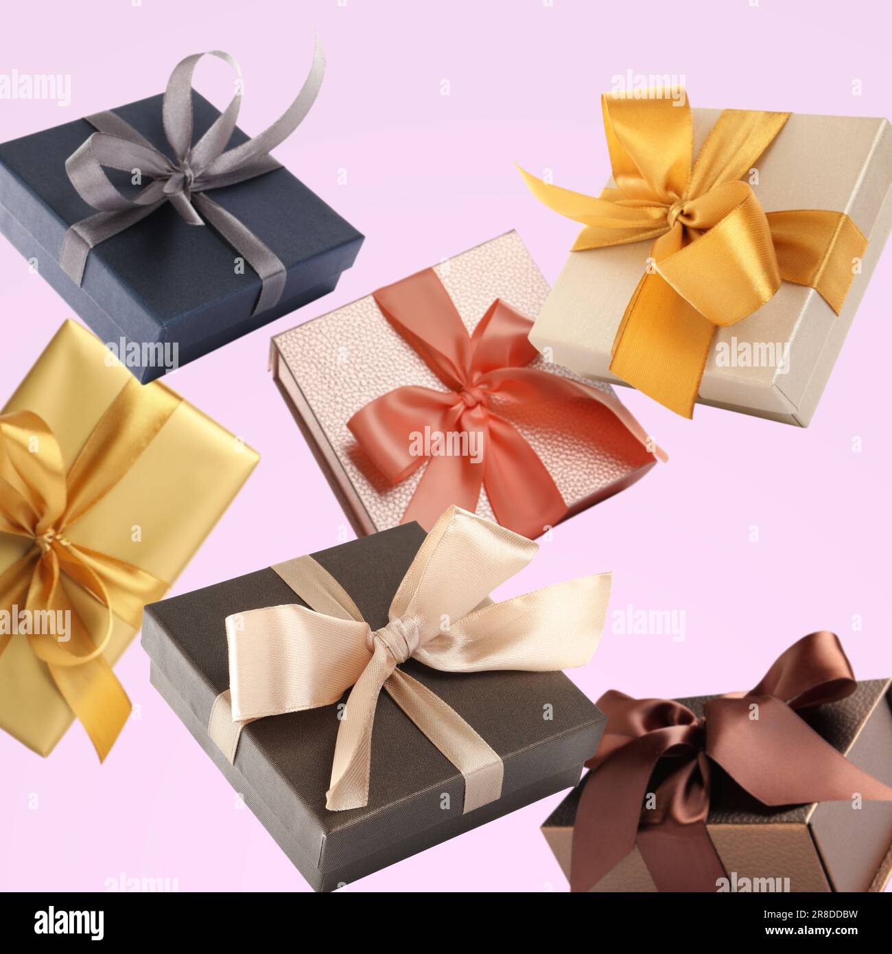 Many beautiful gift boxes falling on pastel pink background Stock Photo ...