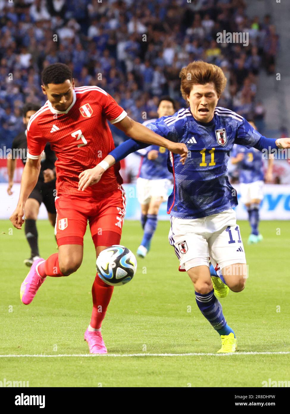 Suita, Japan. 20th June, 2023. Japan's Kyogo Furuhashi (R) fights the ...