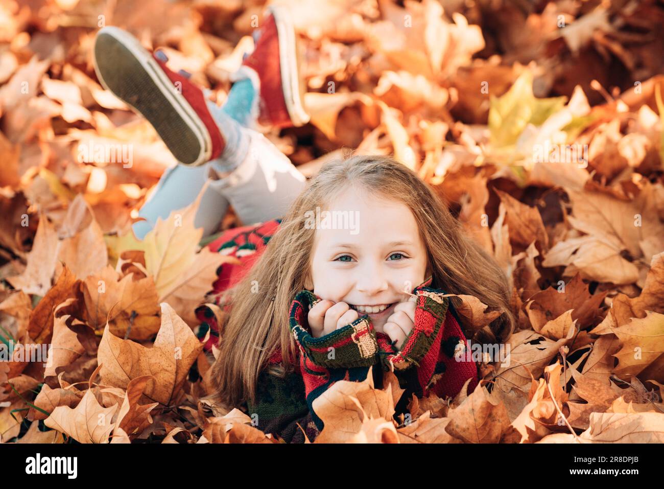 Happy child. Funny kid outdoors in autumn park. Happy child girl in ...