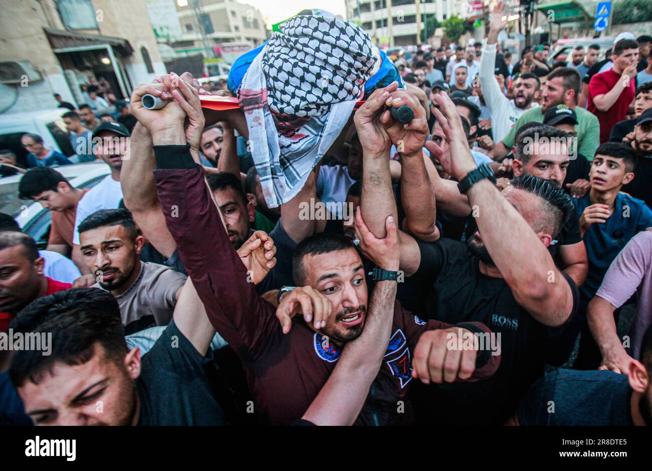 (EDITOR'S NOTE: Image depicts death) Mourners carry the body of the ...