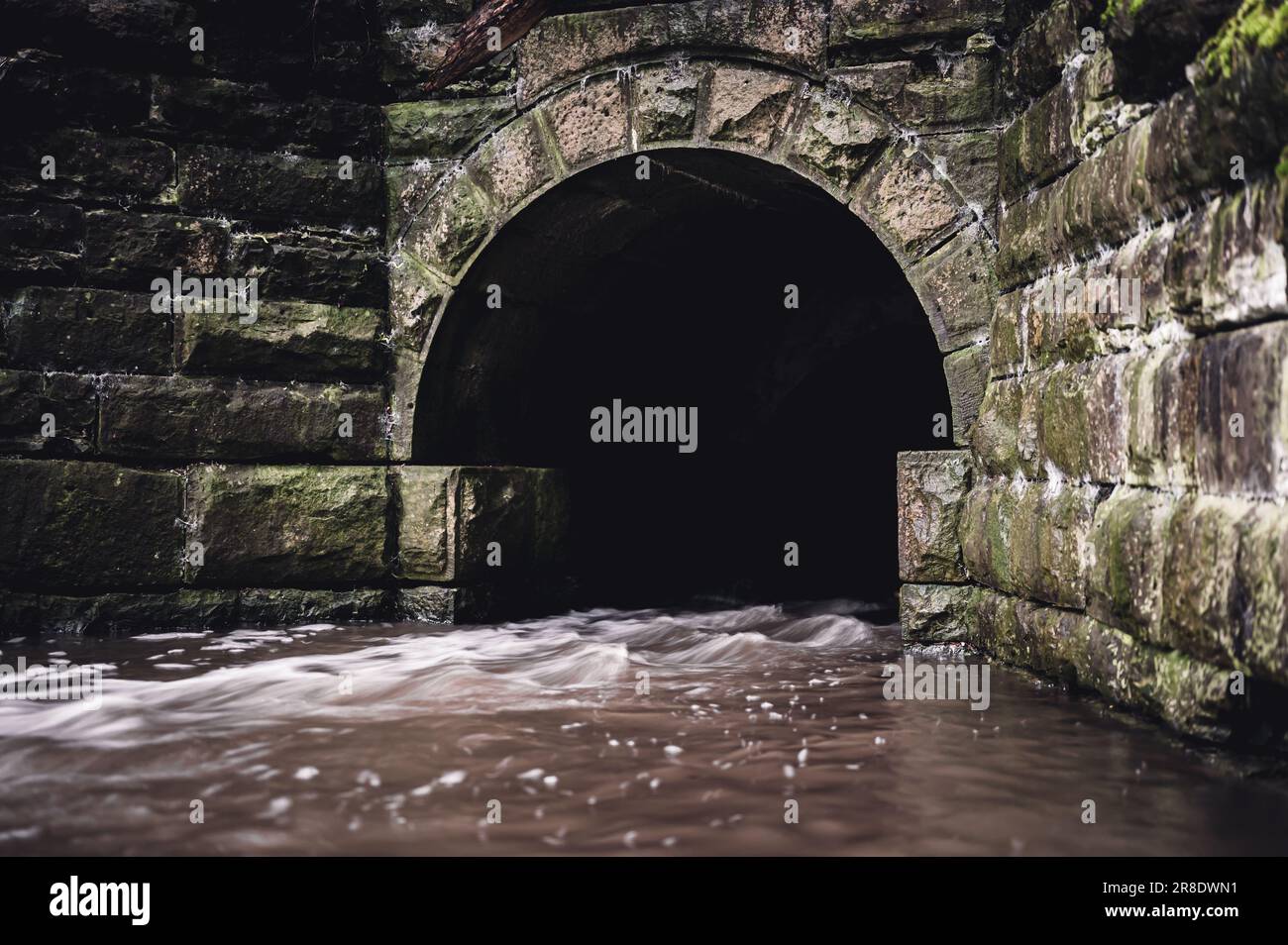 Old stone storm drainage sewer under a roadway Stock Photo - Alamy