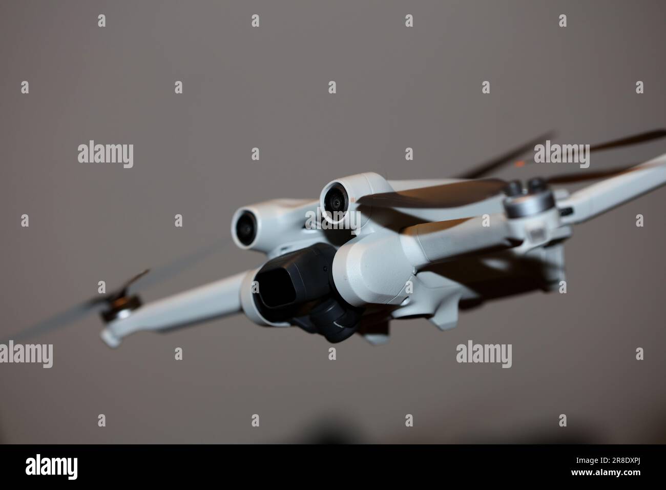 The drone copter flying with digital camera isolated on empty colorful ...