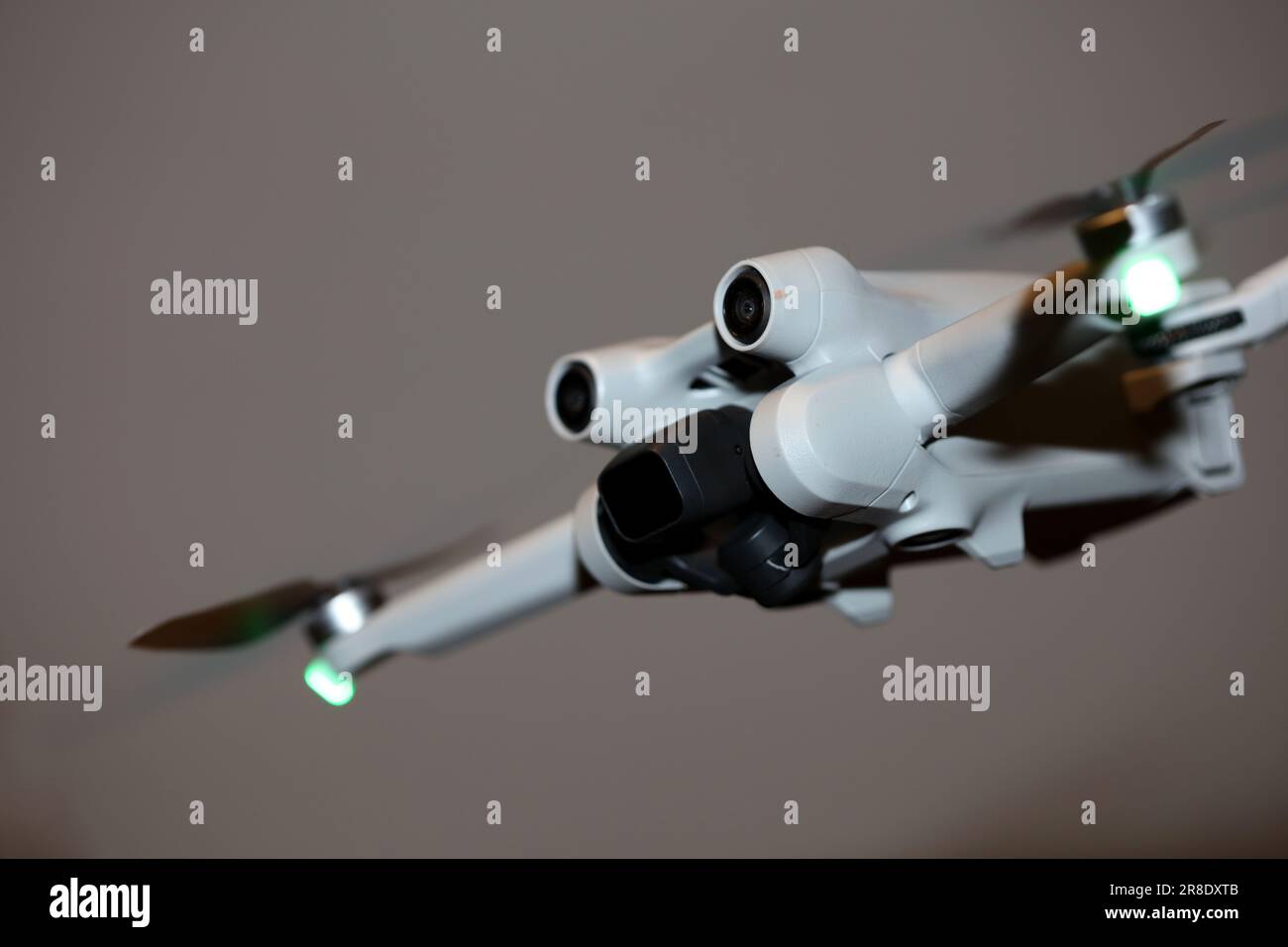 The drone copter flying with digital camera isolated on empty colorful ...