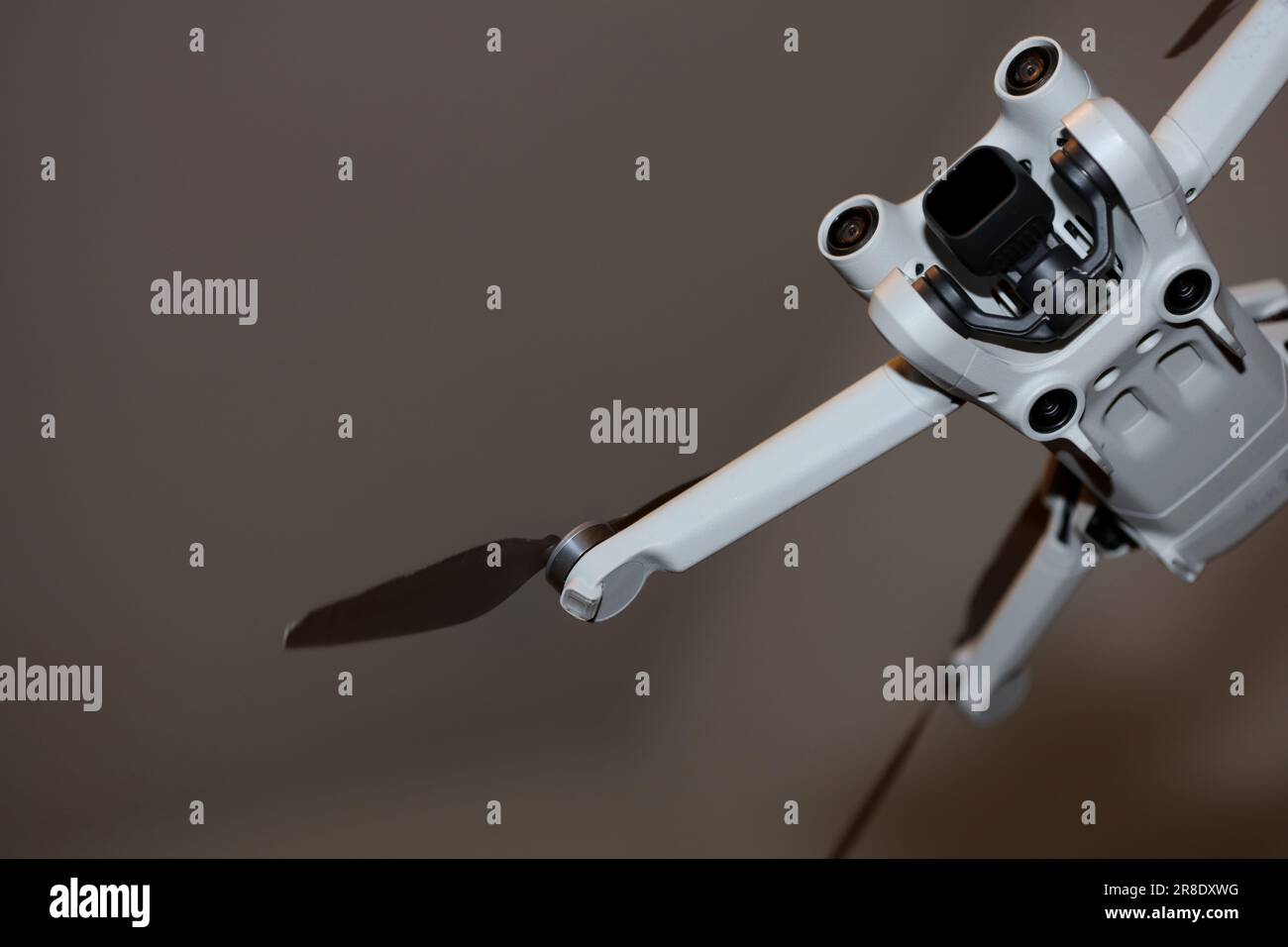 The drone copter flying with digital camera isolated on empty colorful ...