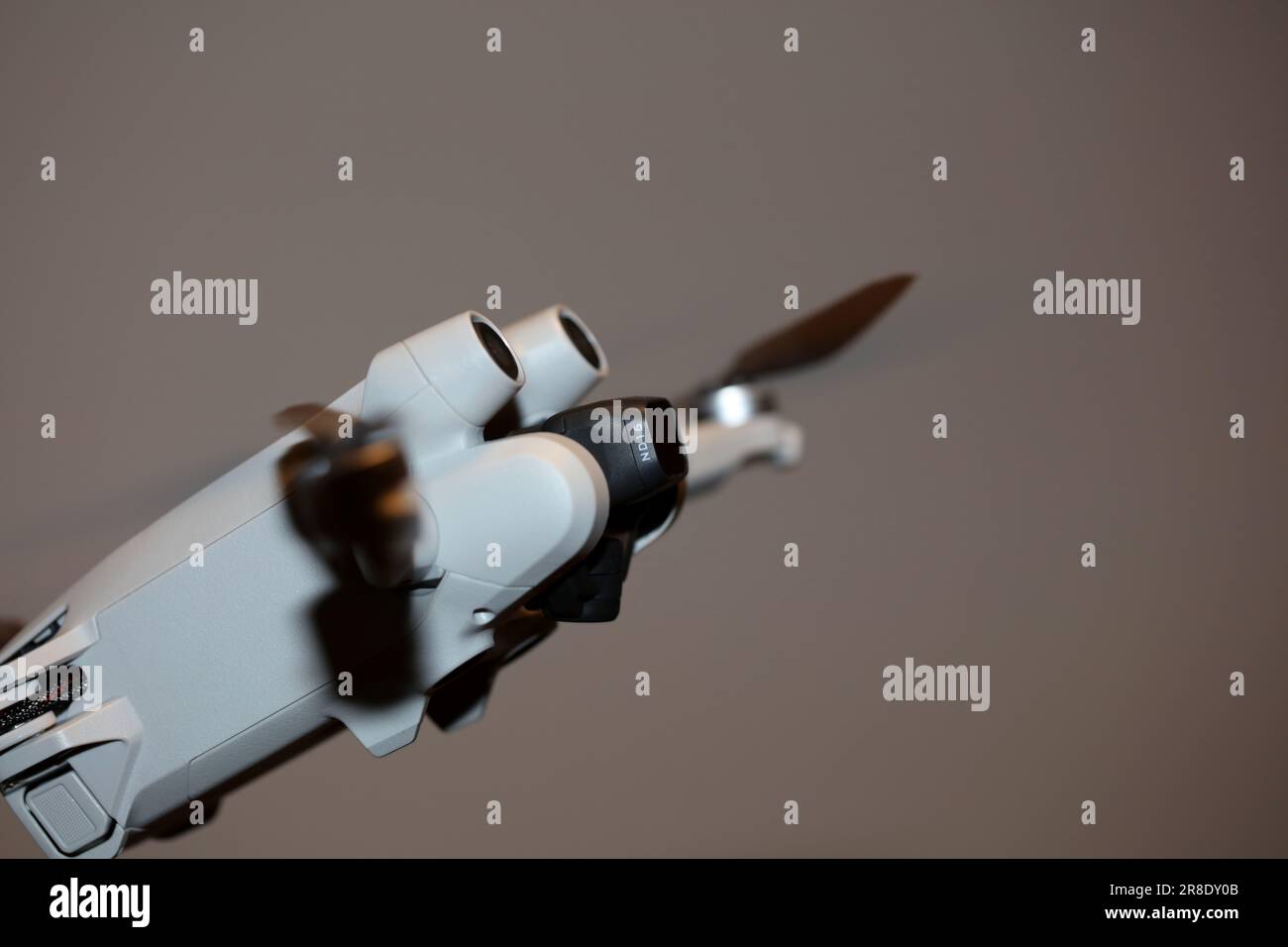 The drone copter flying with digital camera isolated on empty colorful ...